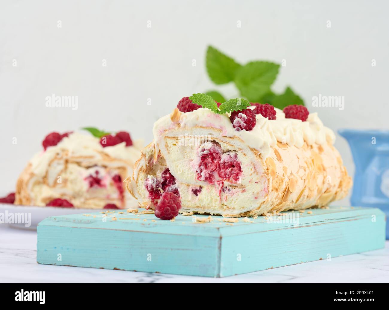 Baked meringue roll with cream and fresh red raspberry, white ...