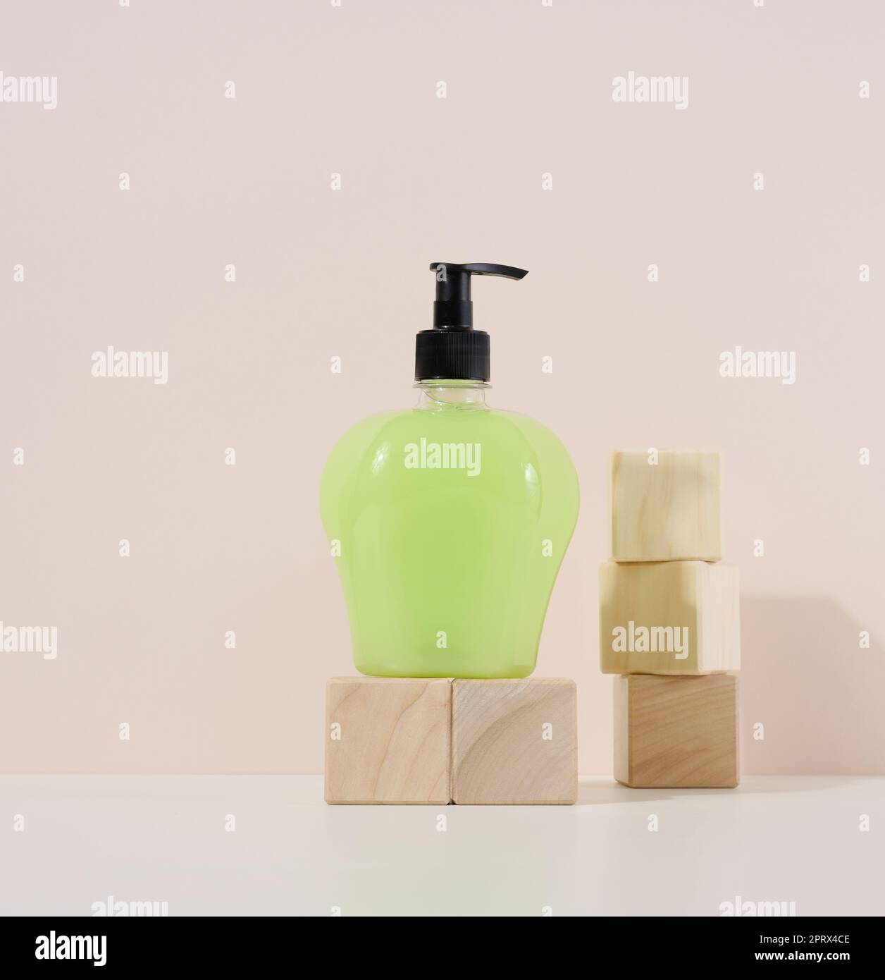 Transparent plastic bottle with green liquid on a wooden podium Stock ...