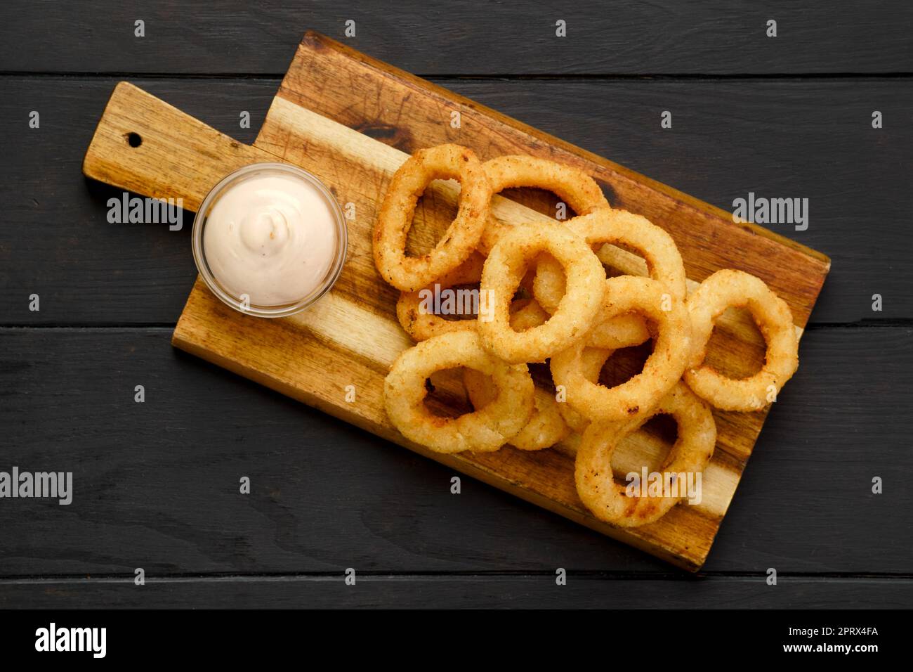 Overhead view of deep fried breaded squid rings with creamy sauce Stock ...