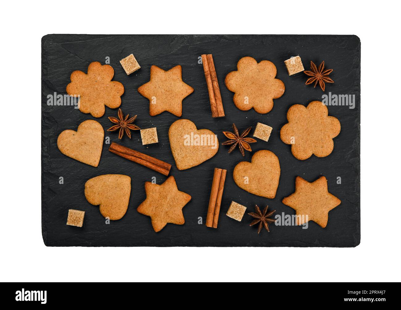 Gingerbread cookies and spices on black slate Stock Photo - Alamy
