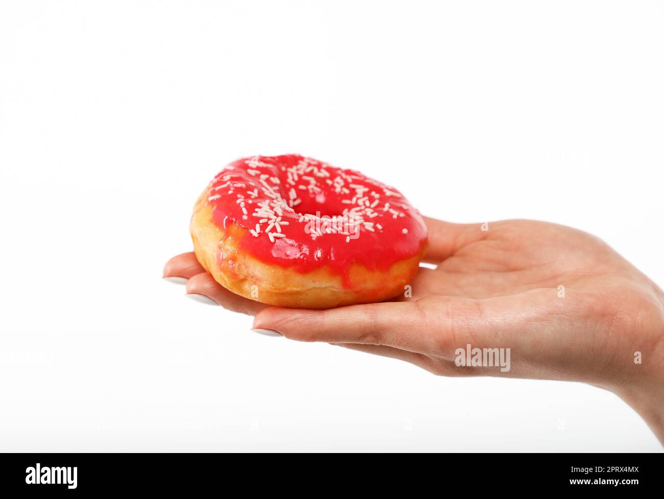 Woman hand holds red donut over white Stock Photo - Alamy