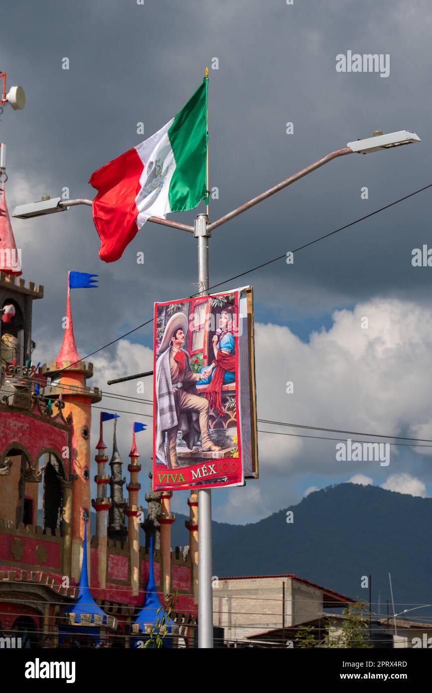 A Mexican flag and banner on a lamp post in Villa de Etla in the ...