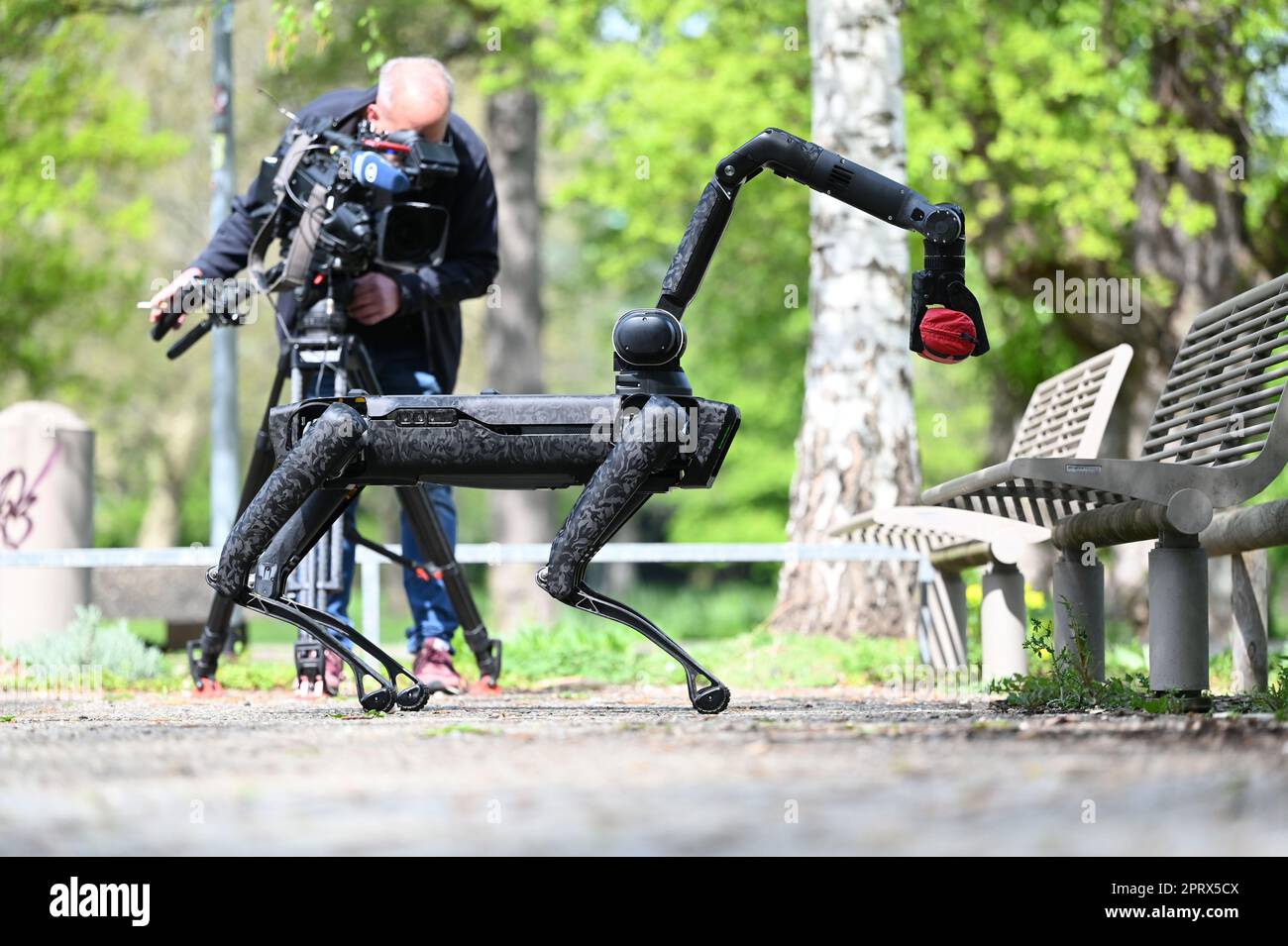 Stuttgart, Germany. 27th Apr, 2023. A walking robot takes an object ...