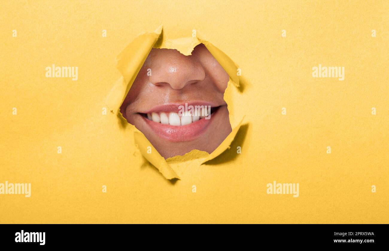Part of the face of the lips and teeth of an African girl through a ...