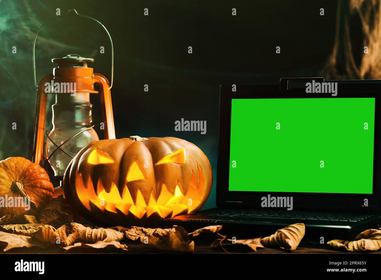 Halloween pumpkins and laptop with green screen in scary deep night ...