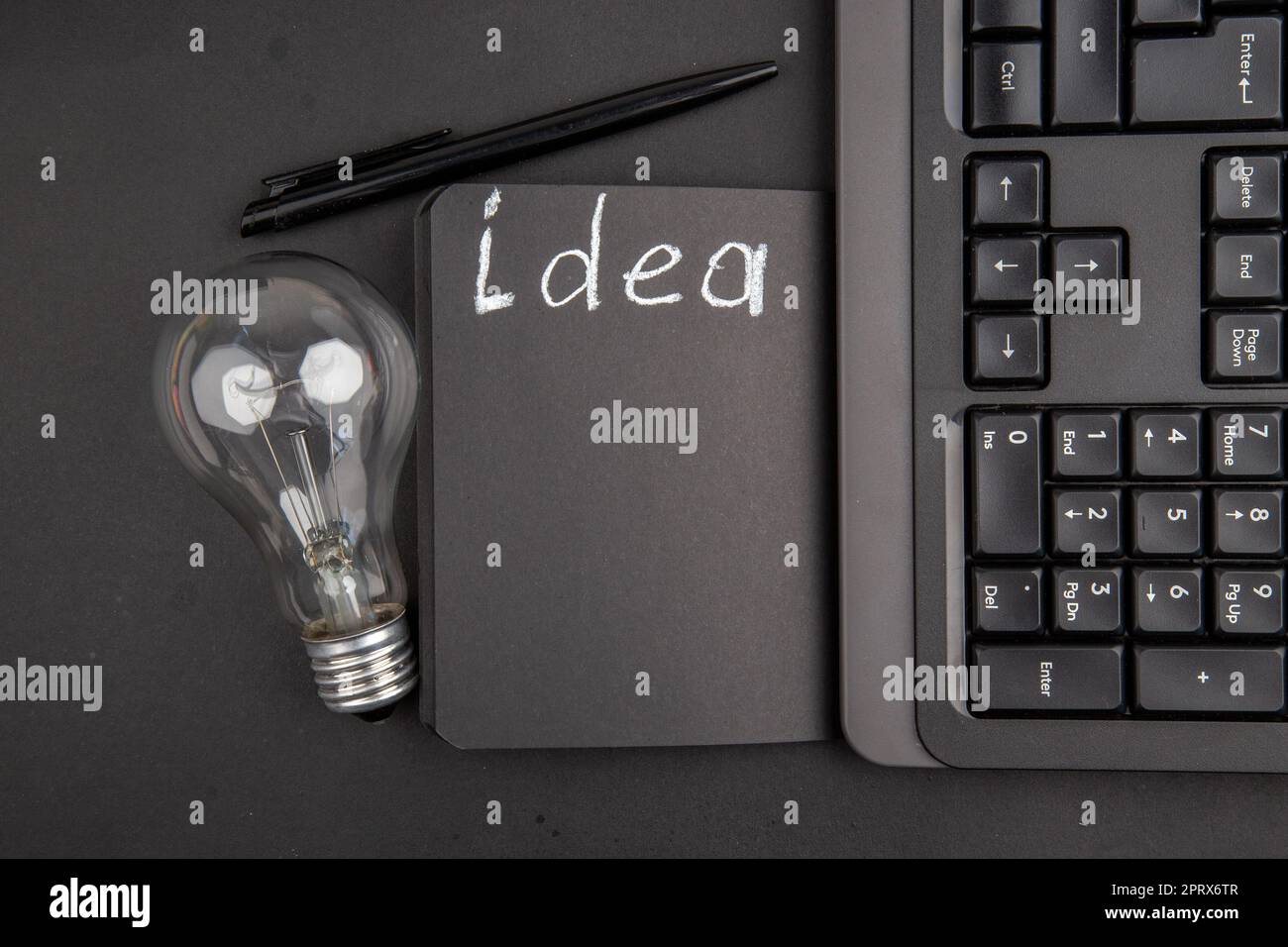 top view office stuffs idea written on notepad light bulb pen keyboard ...