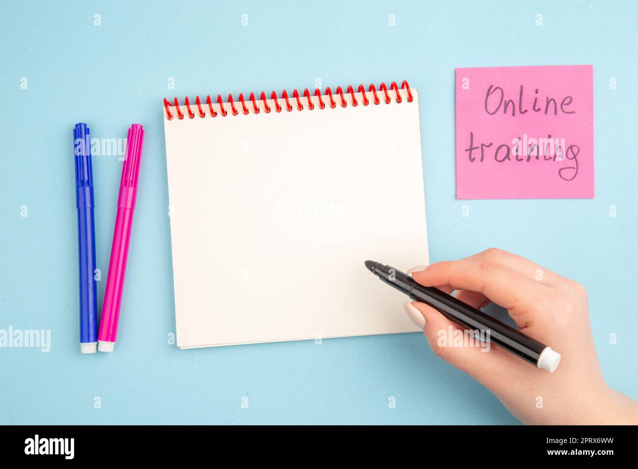 top view online training written on sticky note marker in female hand ...