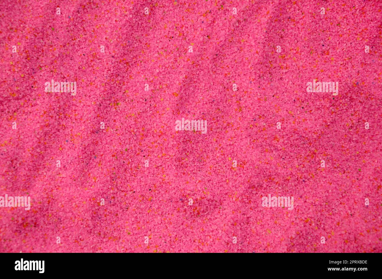 Texture of a colored granular sand close up. Pink grains Stock Photo ...