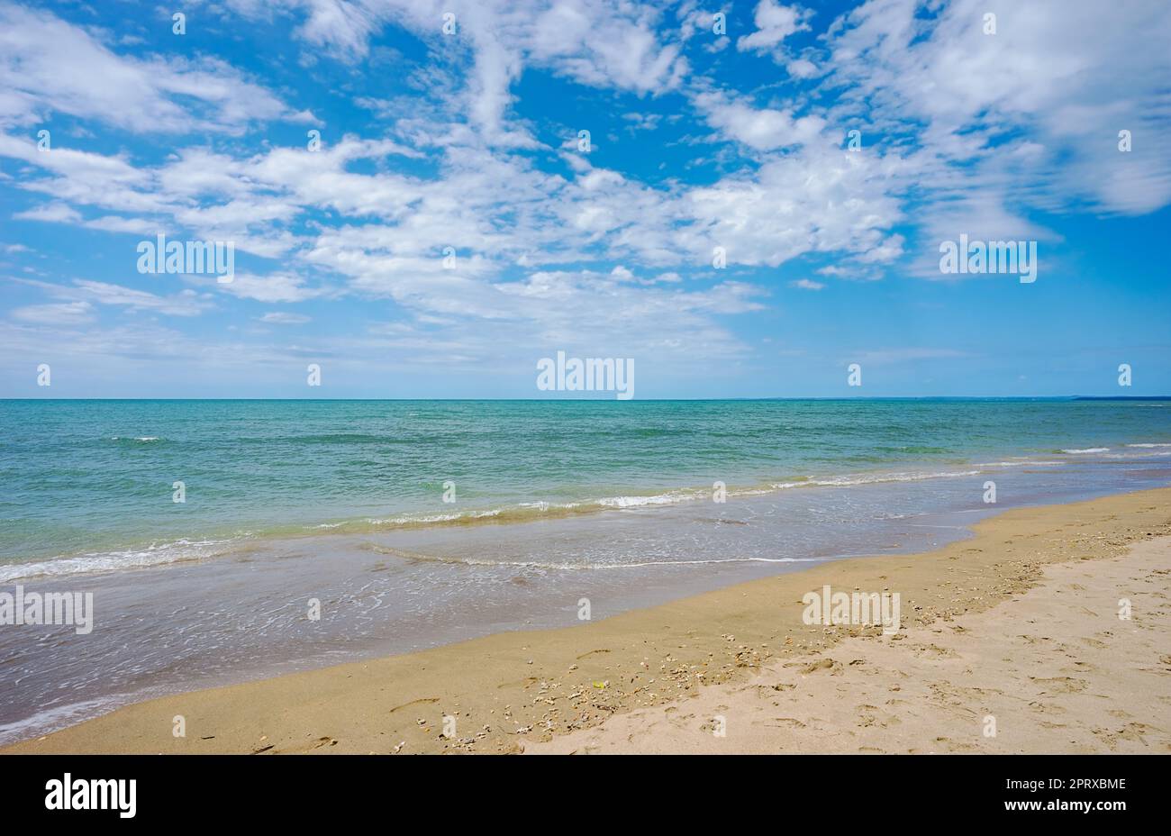Blue cloudy sky and calm blue waters of beautiful Hervey Bay on a sunny ...