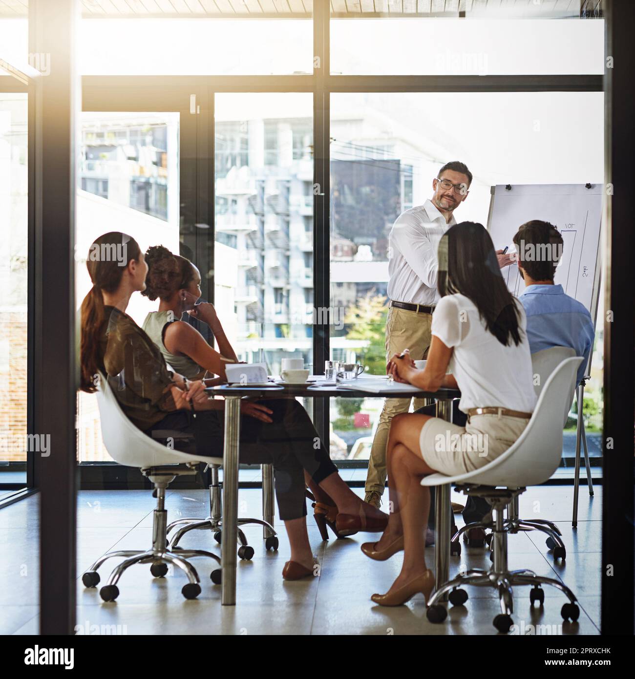 Leading his team through an important presentation. a group of man ...
