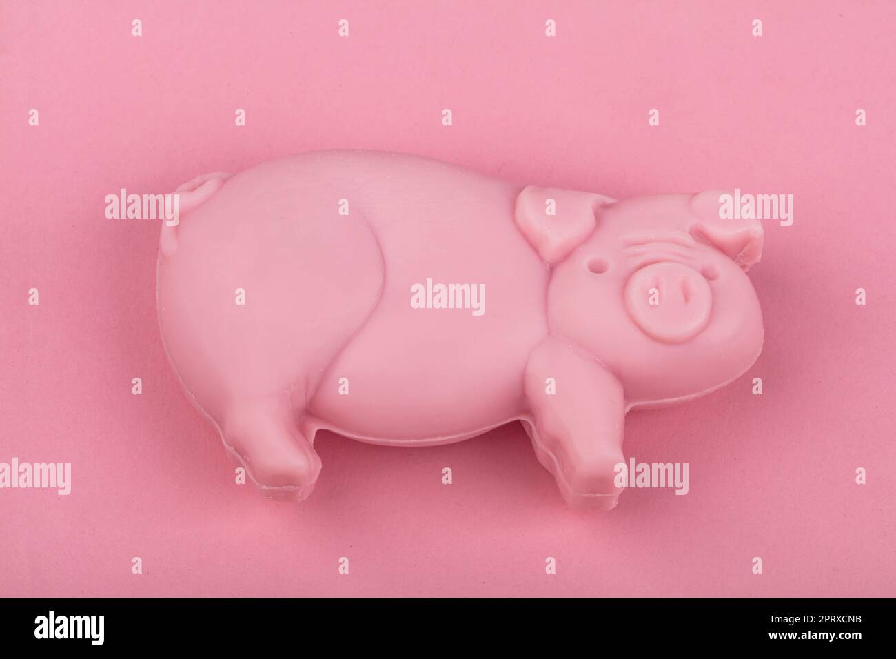 Piece of soap in shape of a Pig from above over pink background Stock ...