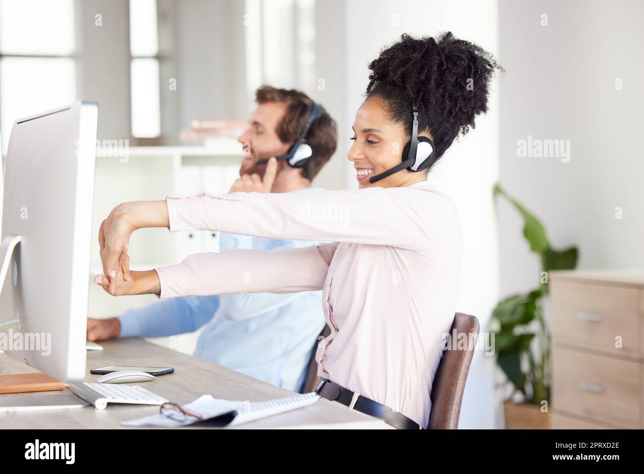 Black woman, call center and stretching at desk with smile for work in contact us, customer ...