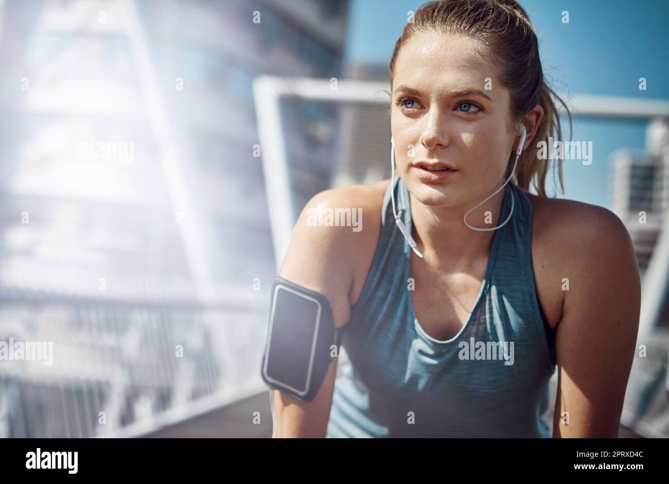 Just a quick breather. a sporty young woman looking tired during a run ...