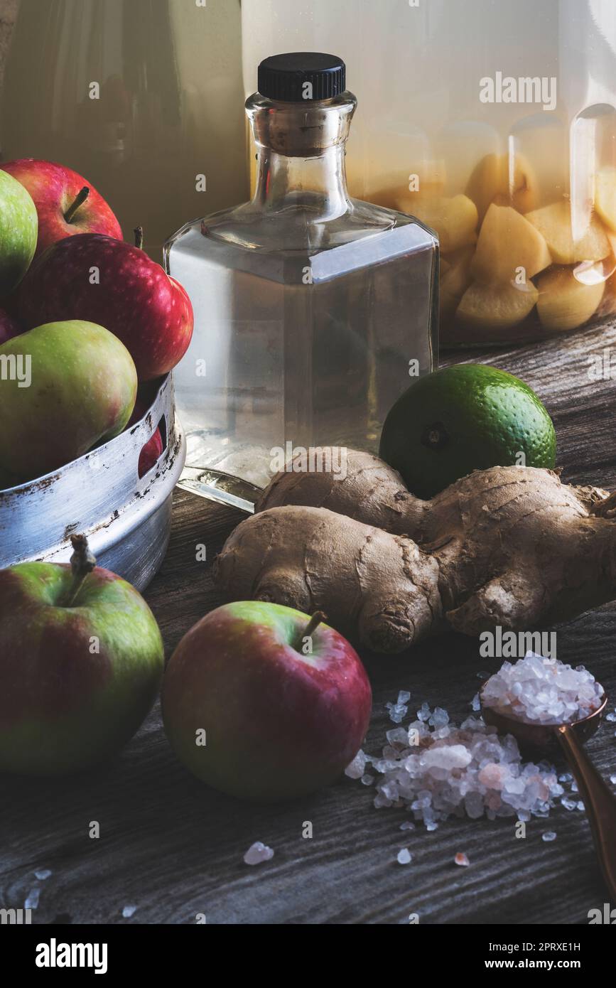 Bottle of apple cider vinegar on rustic background with organic apples ...