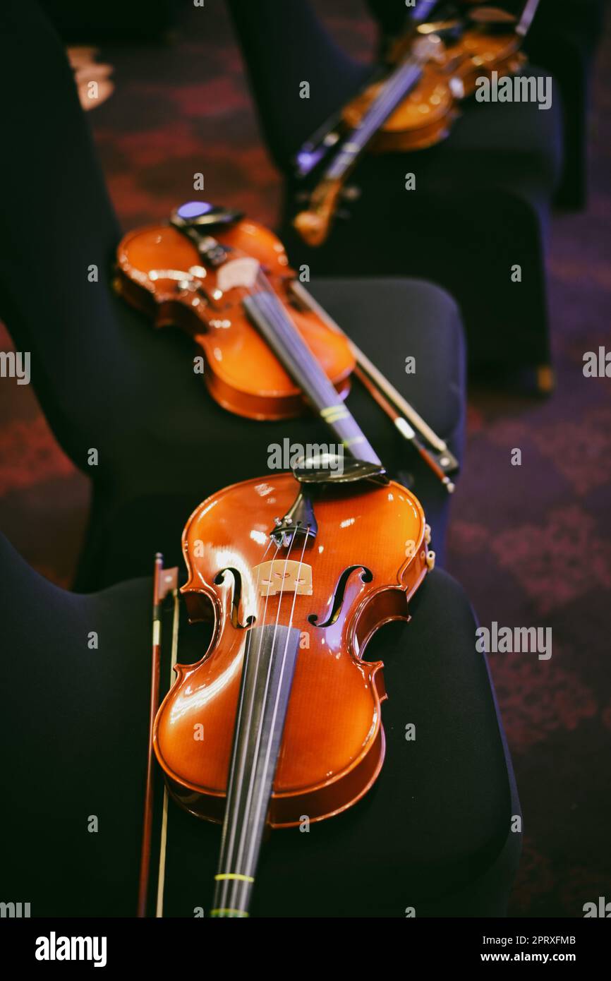 Detail view of two violins on some chairs Stock Photo - Alamy