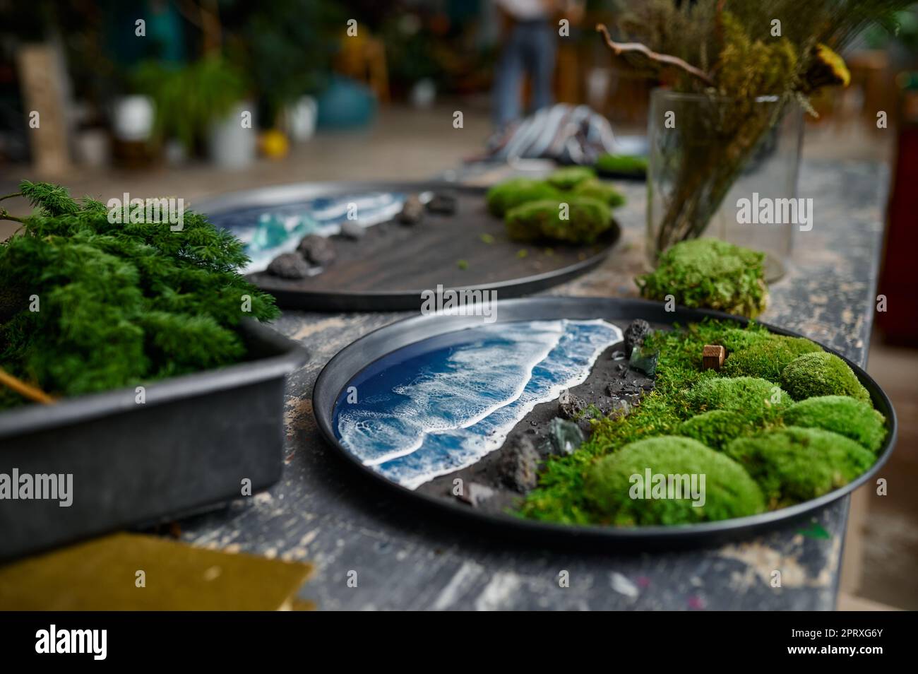 Artist workplace selective focus. Board with moss pieces, stone and ...