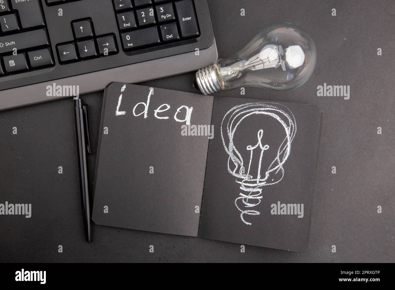 top view idea light bulb drawing on notepad keyboard pen light bulb on ...