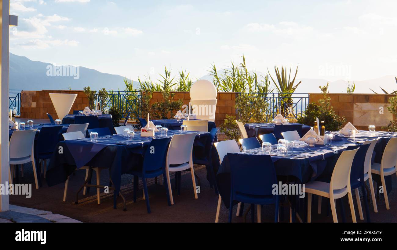 Restaurant, cafe on outdoor terrace with view of sky and mountains ...
