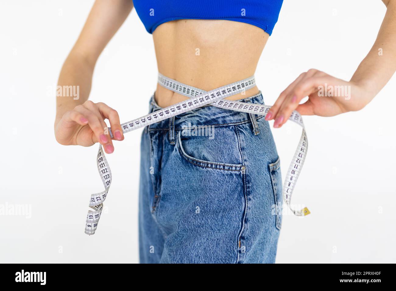 young girl measuring her waist isolated on a white background Stock ...