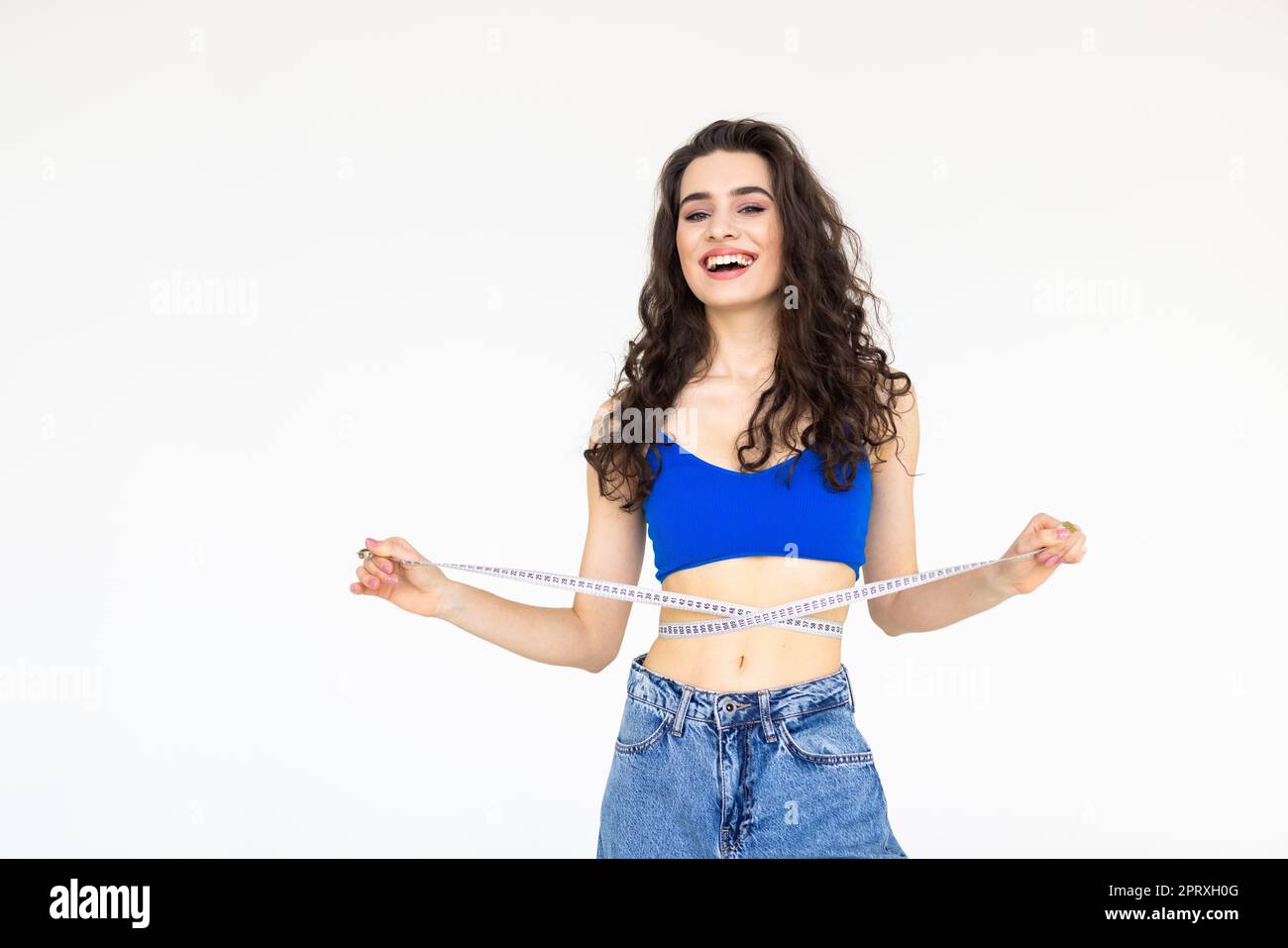 young girl measuring her waist isolated on a white background Stock ...