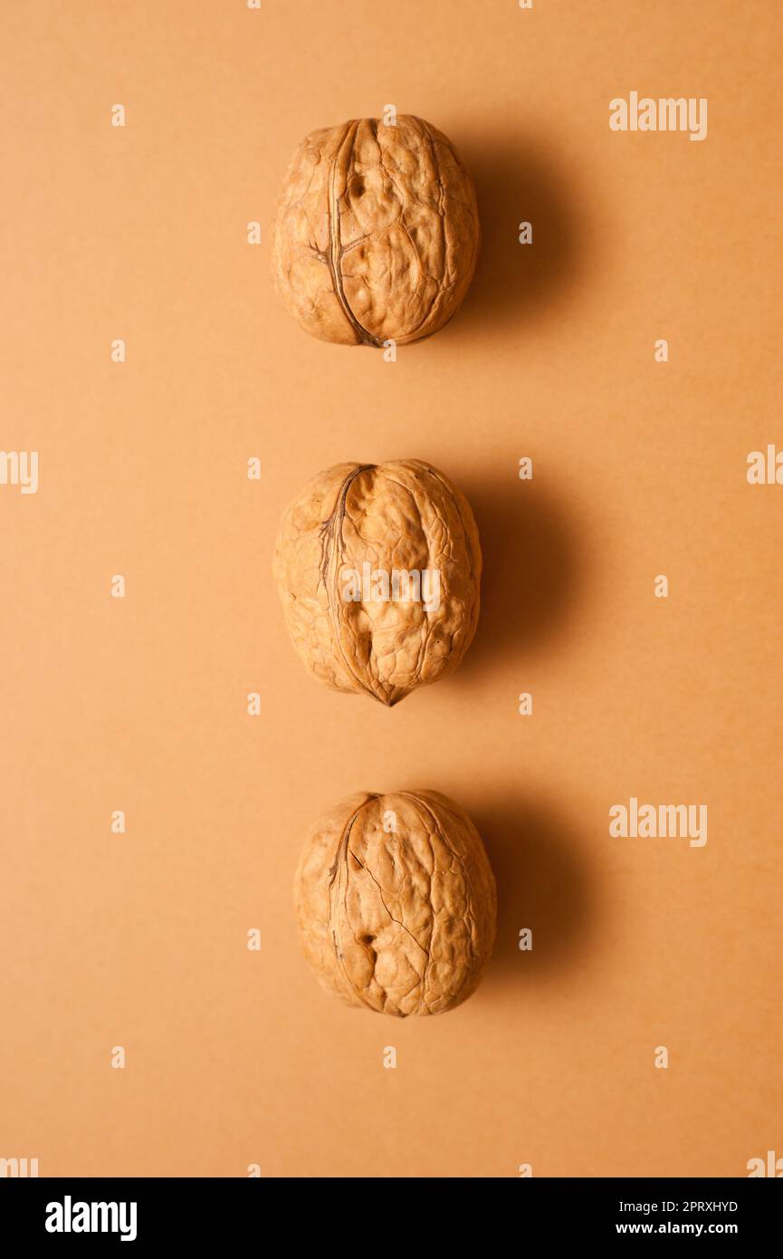 three raw walnuts in a line Stock Photo - Alamy