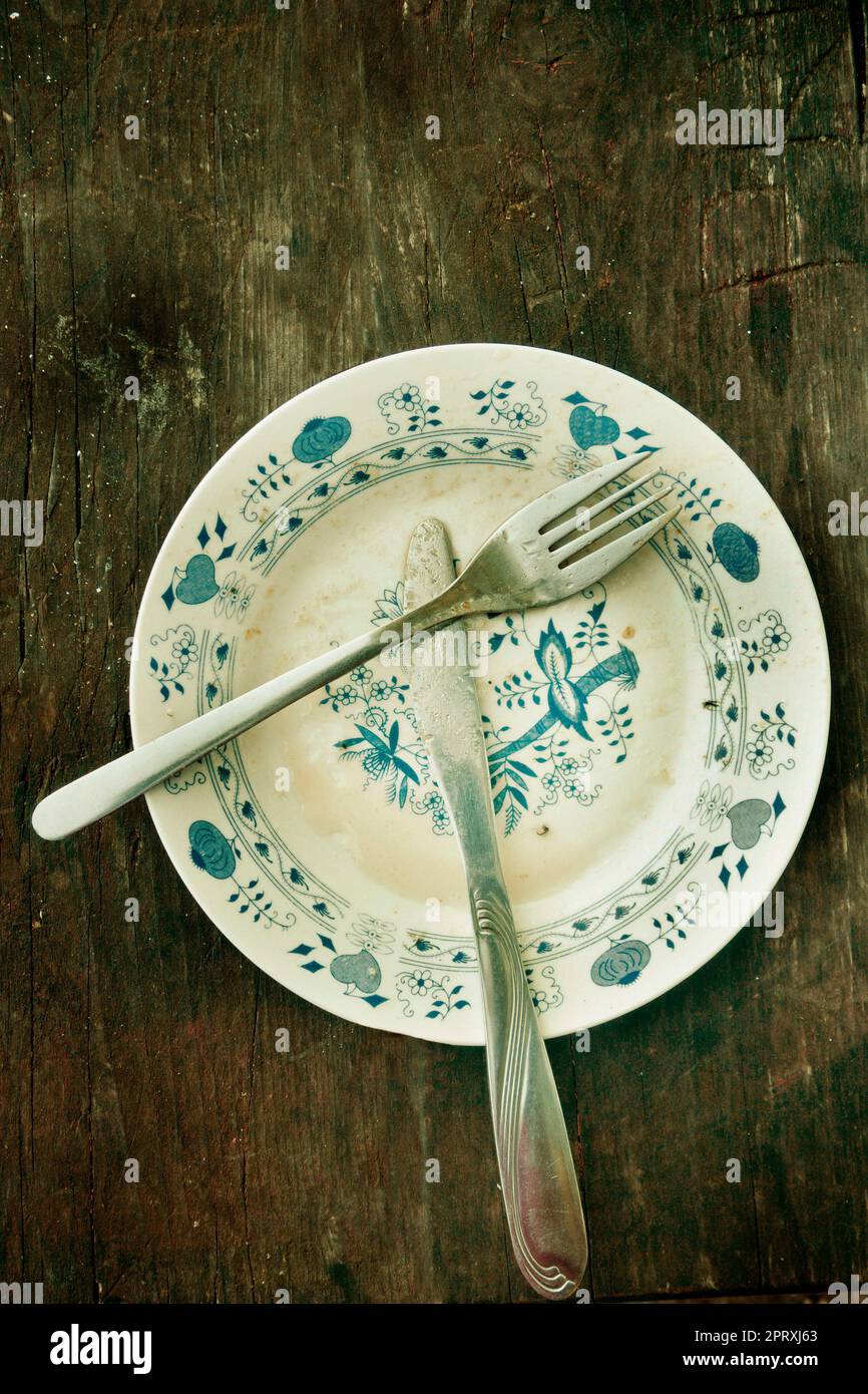 vintage plate on a rustic wood table, with fork and knife Stock Photo ...