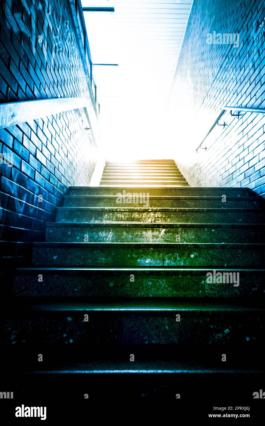 staircase leading to a bright light up Stock Photo - Alamy
