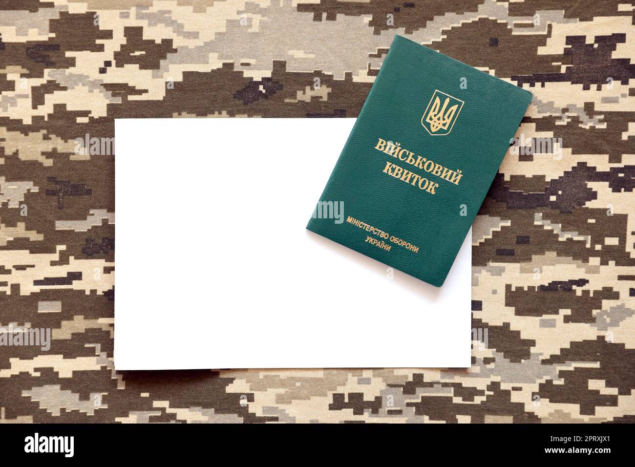 Ukrainian military ID and blank paper sheet on fabric with texture of ...