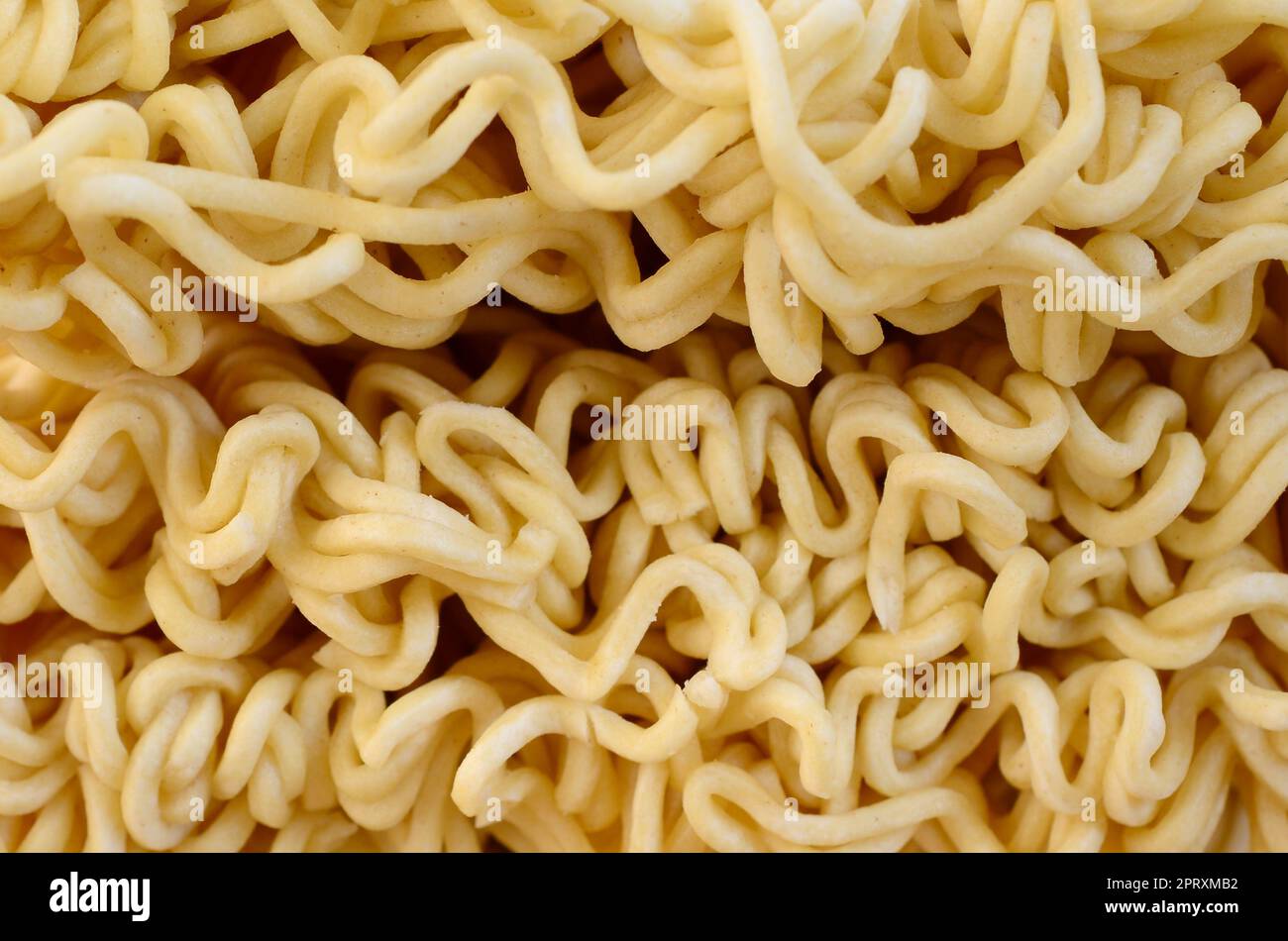 Close up view of yellow dry instant noodles. Chinese traditional food ...