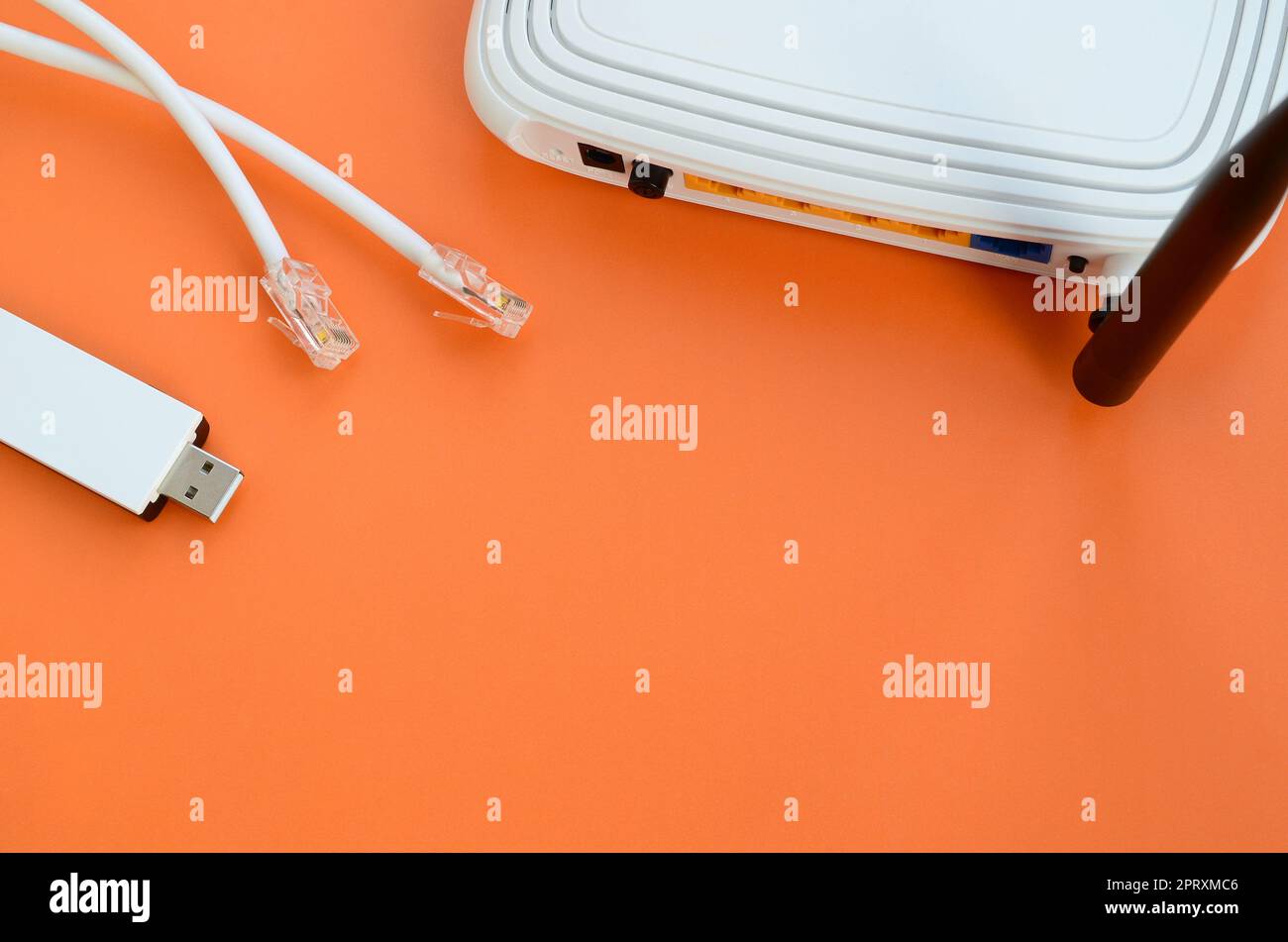 Internet Router Portable Usb Wi Fi Adapter And Internet Cable Plugs Lie On A Bright Orange