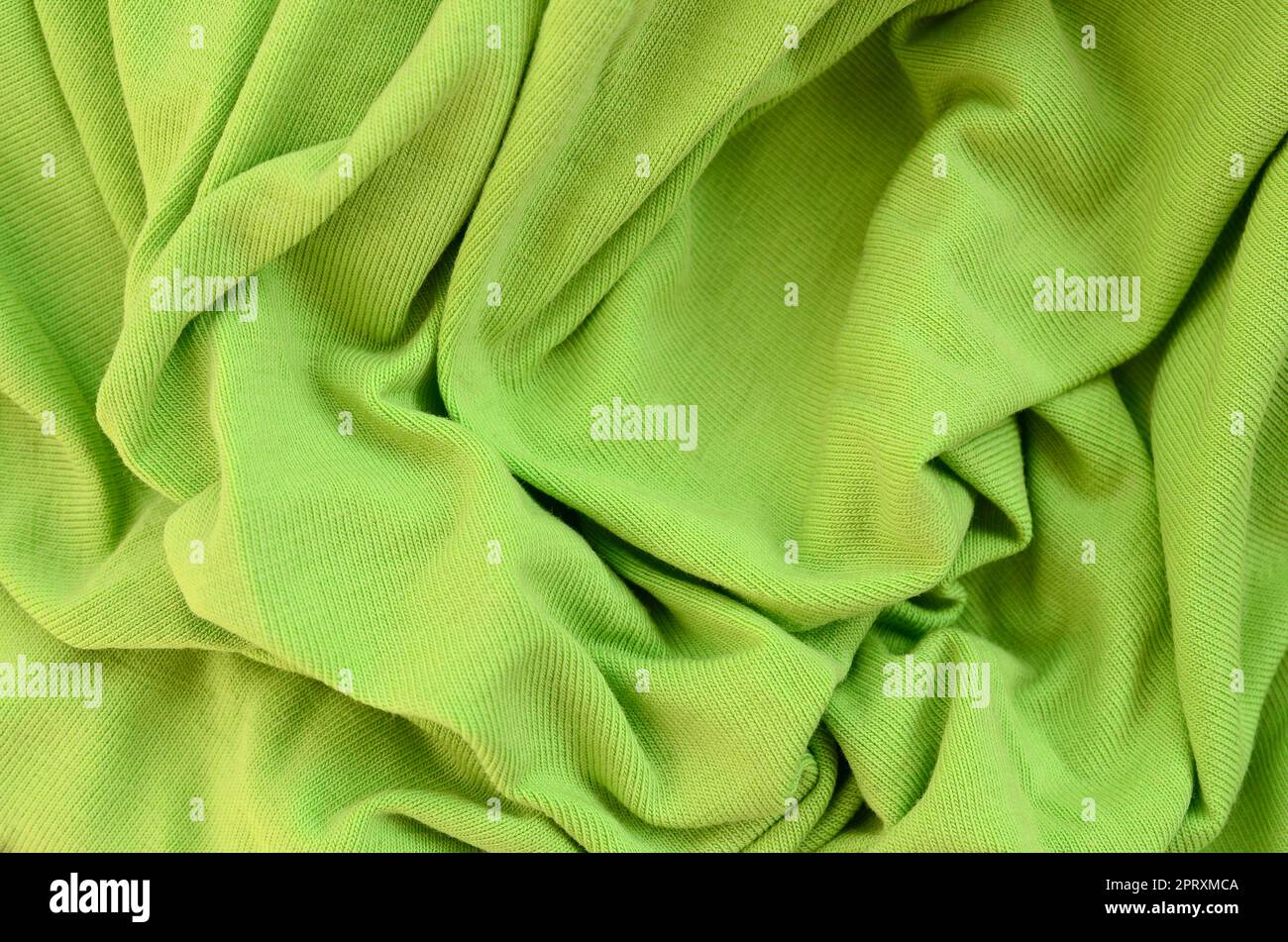 The texture of the fabric is bright green. Material for making shirts ...