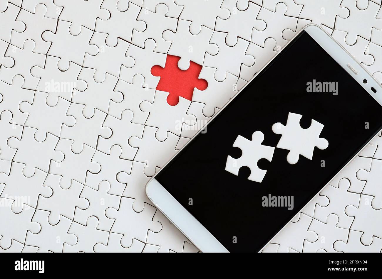 A modern big smartphone with several puzzle elements on the touch ...