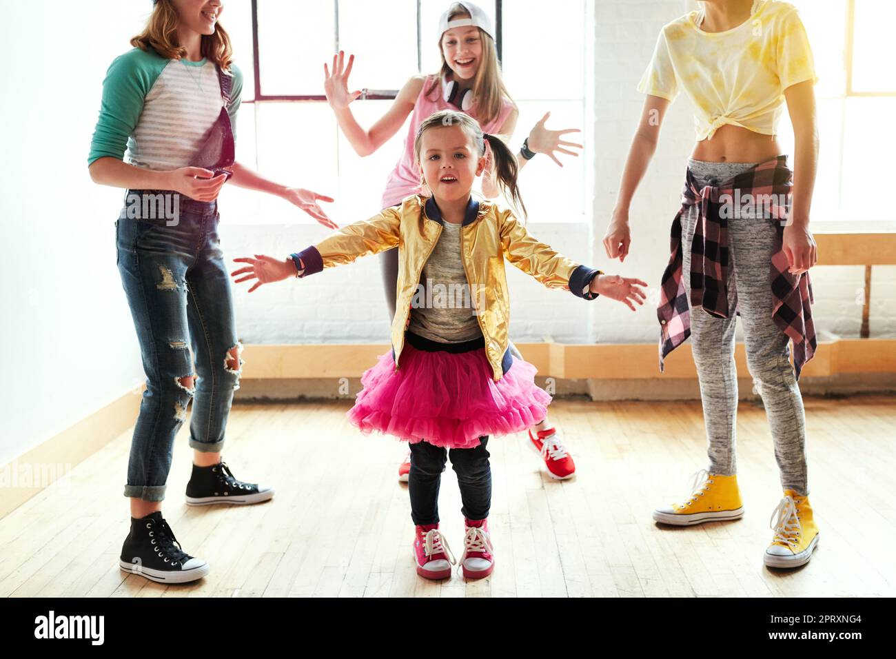 Teaching the little one how to groove. young girls dancing in a dance ...