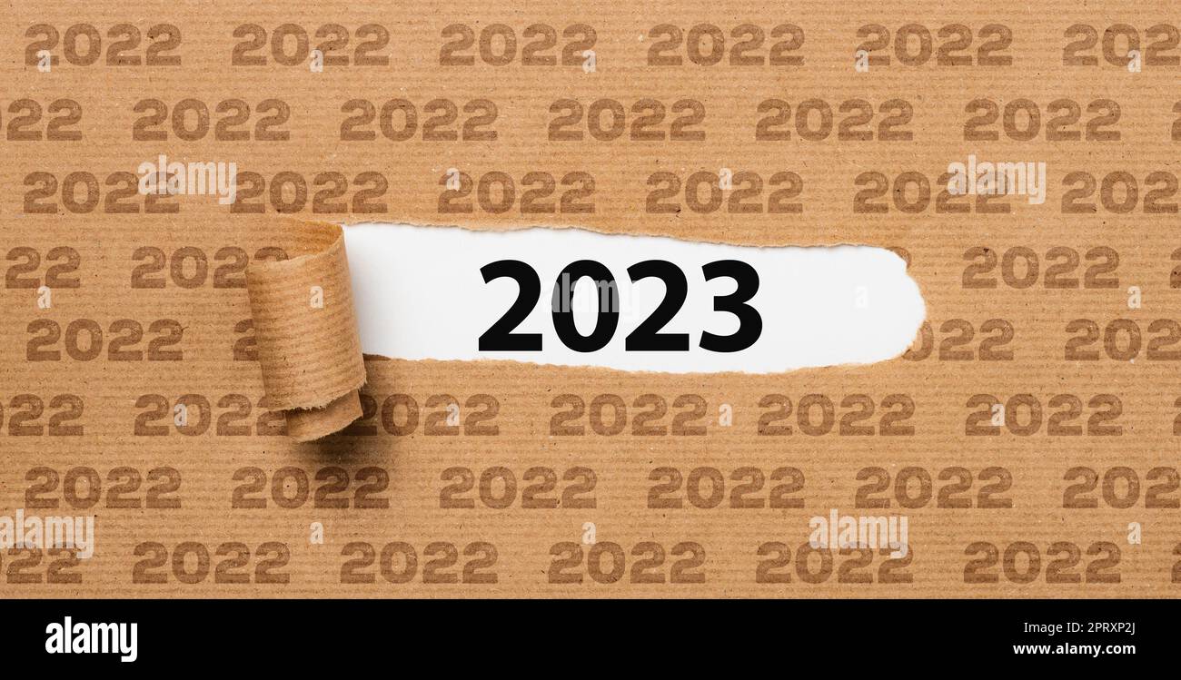 Torn paper revealing the number 2023 Stock Photo - Alamy