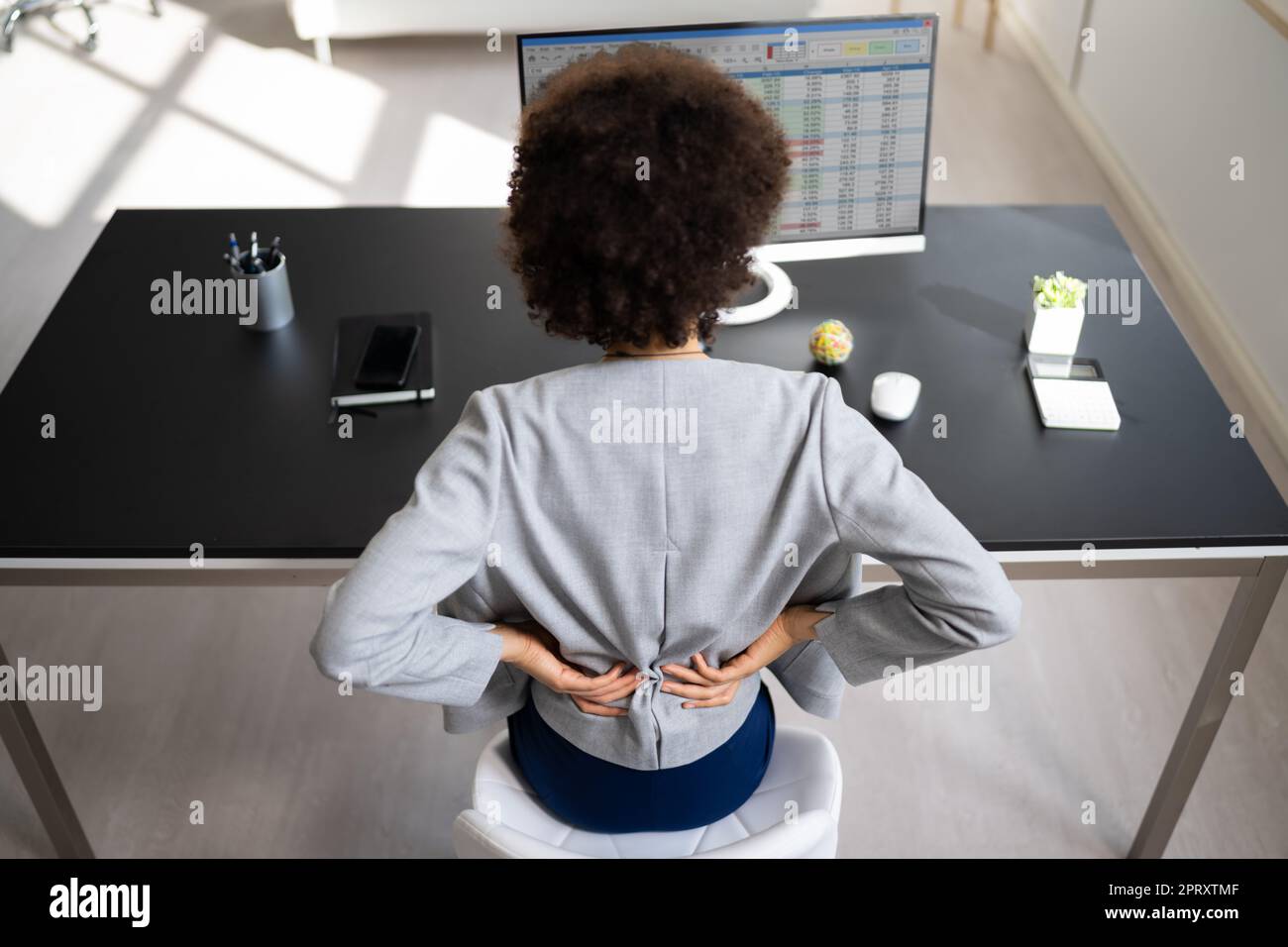 Back Pain Bad Posture Woman Sitting In Office Stock Photo - Alamy