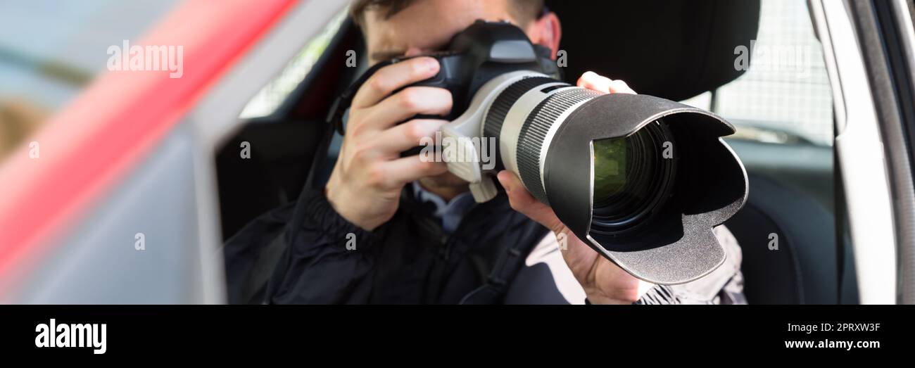 Private Investigator Detective Using Camera In Car Stock Photo - Alamy