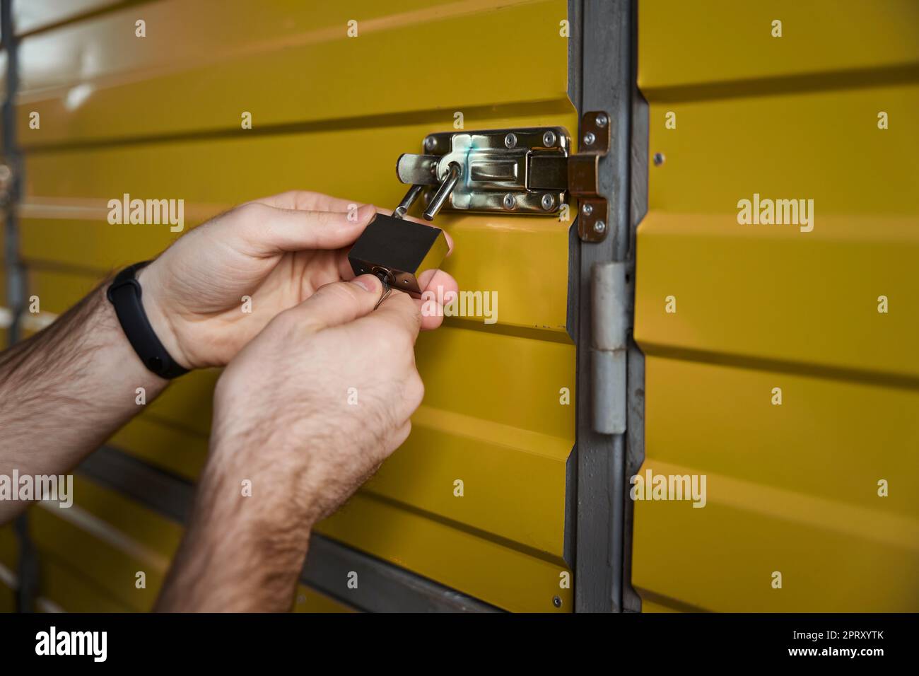 Close-up photo of man hands opening the lock Stock Photo - Alamy