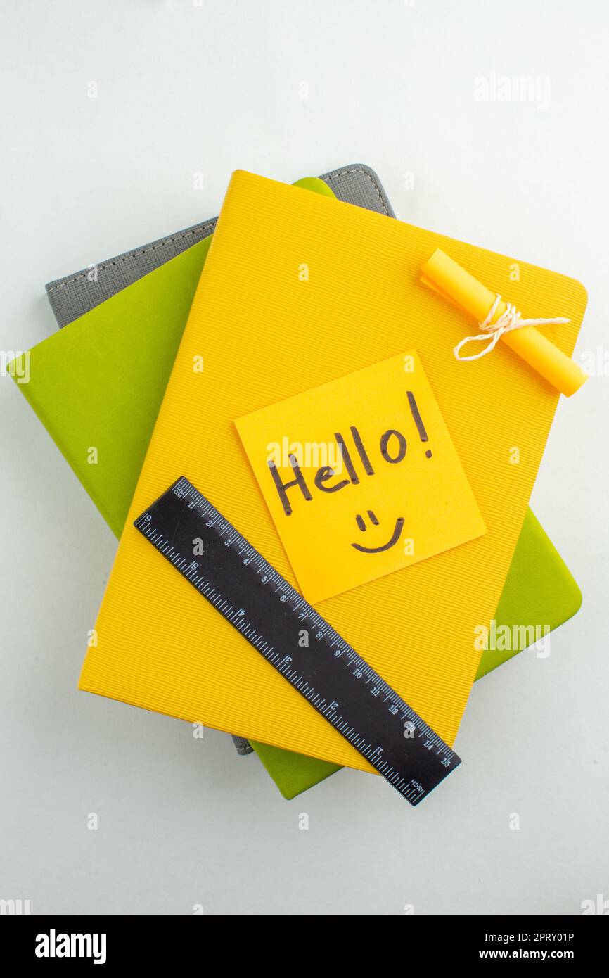 top view hello written on sticky note ruler on colorful notepads on ...
