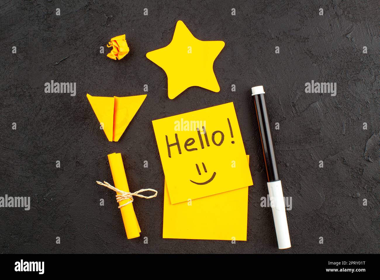 top view hello written on sticky note rolled up note paper tied with ...
