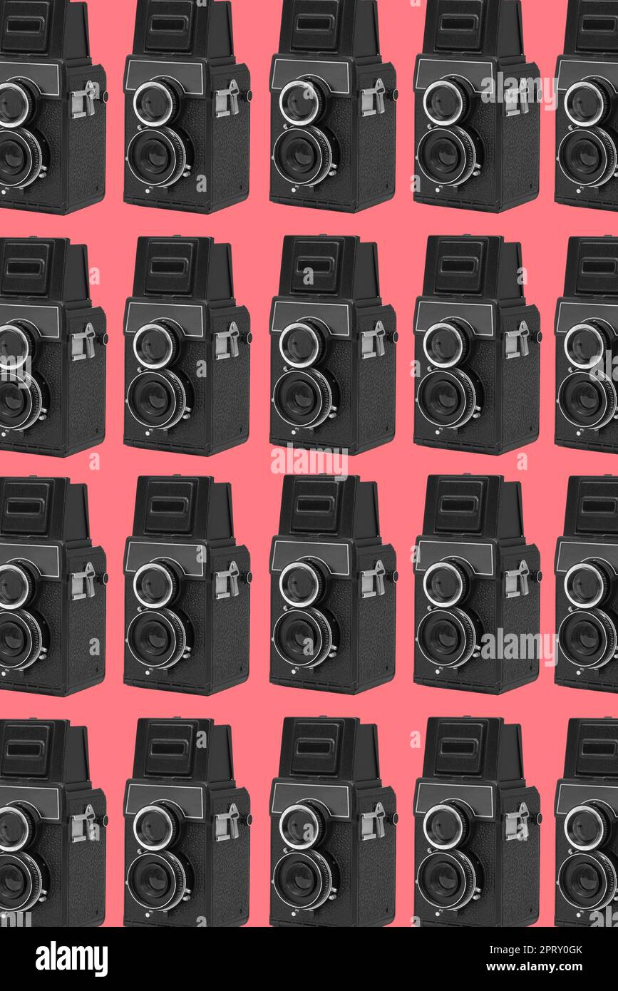 some black retro medium format film cameras arranged in different lines ...
