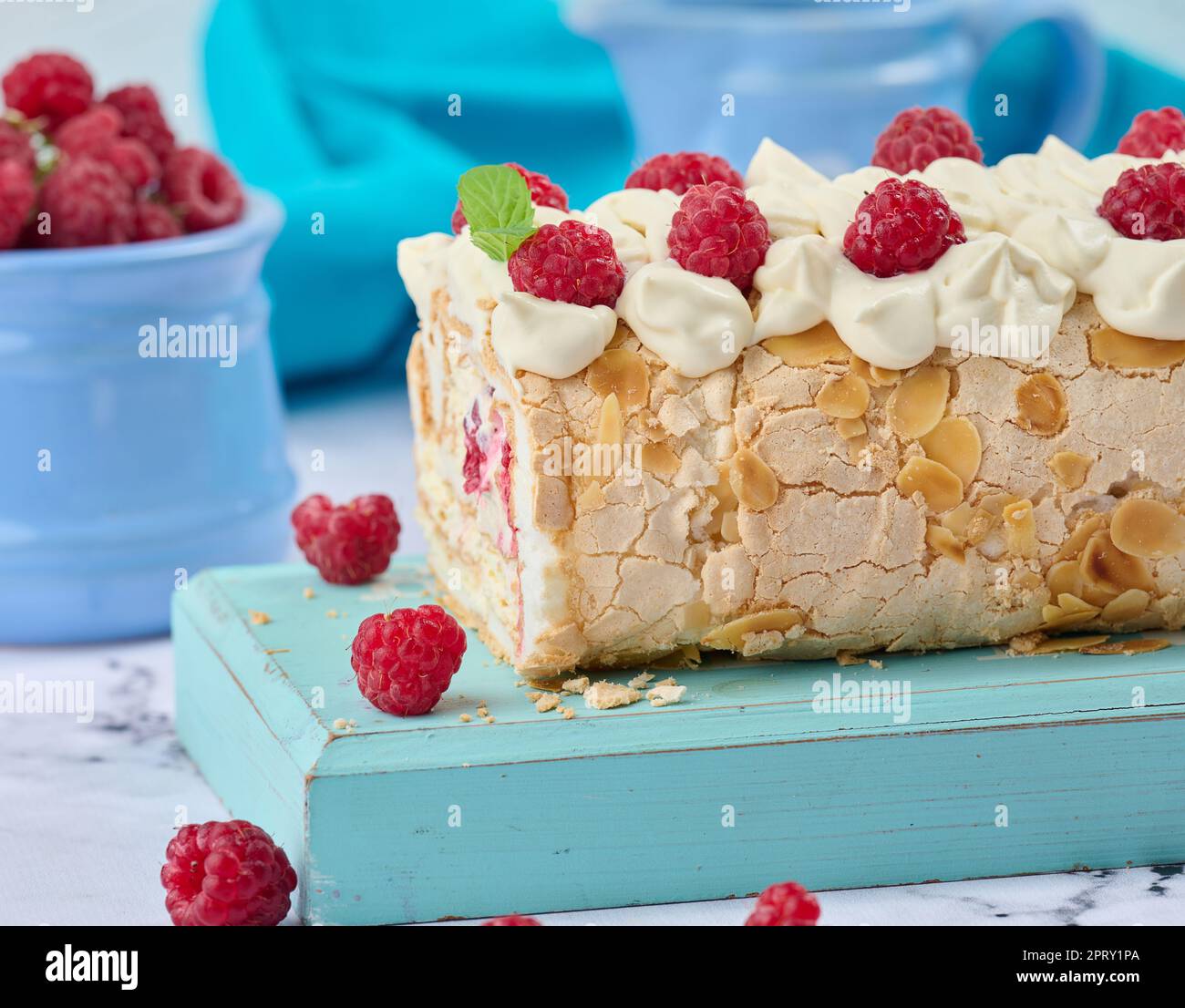 Baked meringue roll with cream and fresh red raspberry, white ...