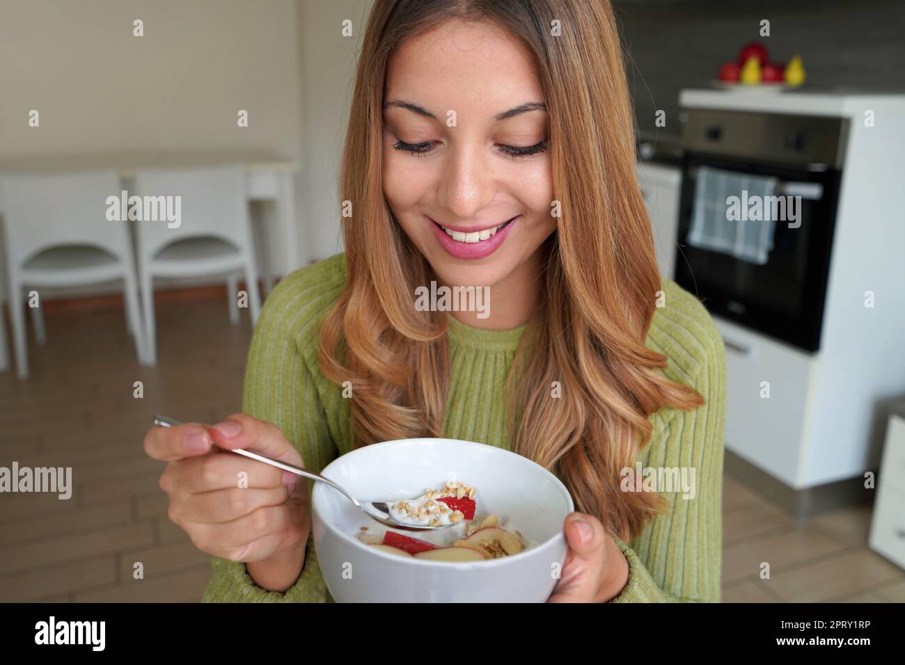 Teenage girl eating muesli granola oatmeal with fruits and yogurt Stock ...