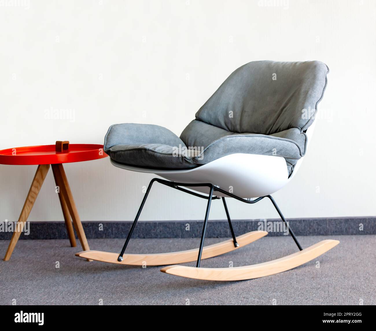 The rocking chair and table against the wall. Interior inside Stock ...