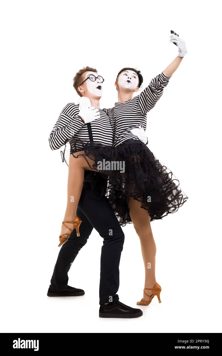 Smiling mimes in striped shirts. couple mimes making selfie on camera ...