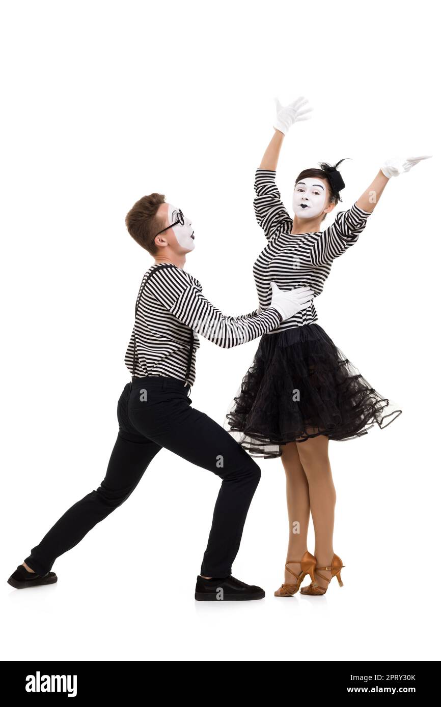 Full-length portrait of mimes in striped shirts. Man and woman dressed ...
