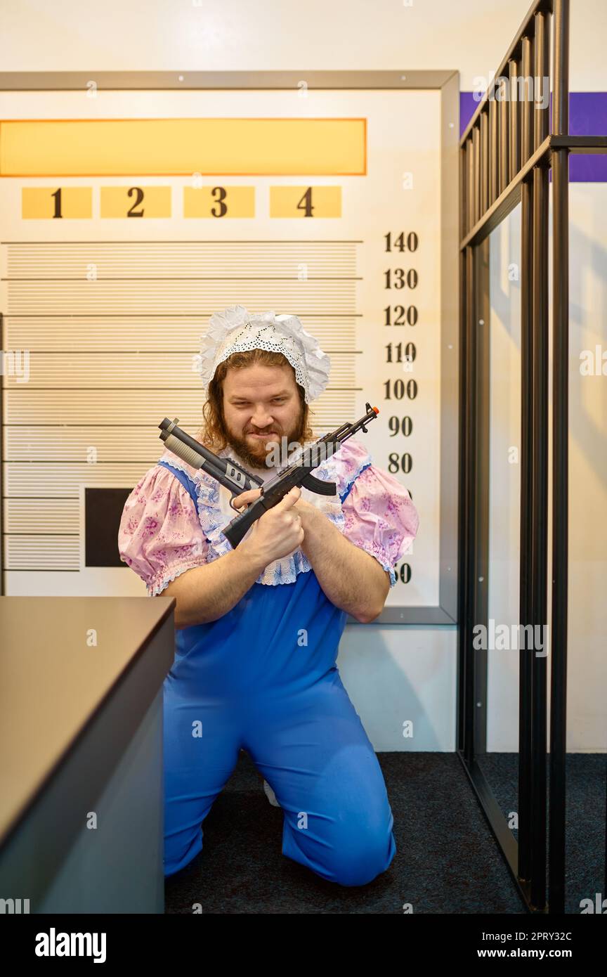 Funny baby man criminal posing with weapon at playroom police station ...