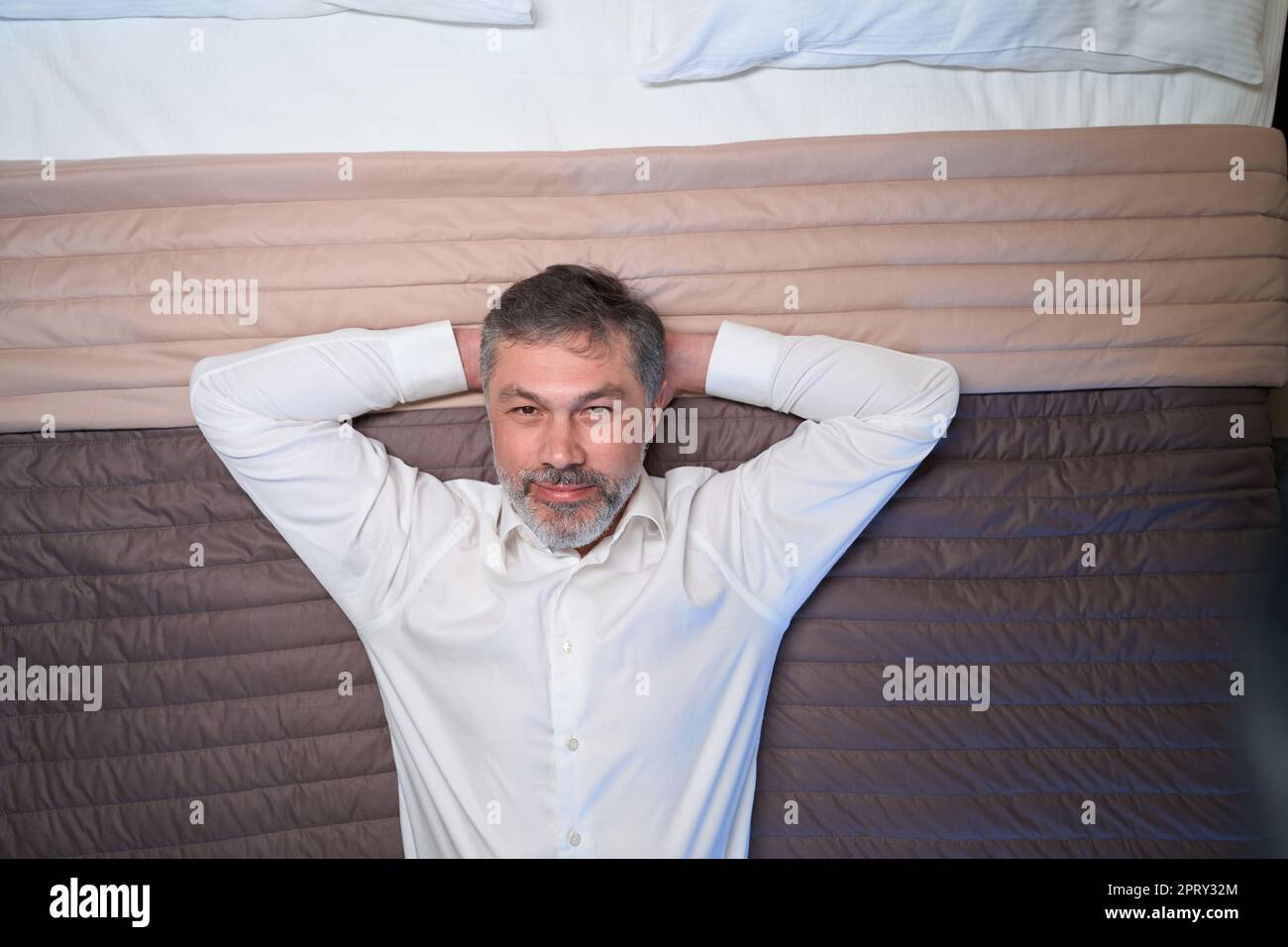 Close up photo of man lying on bed Stock Photo - Alamy