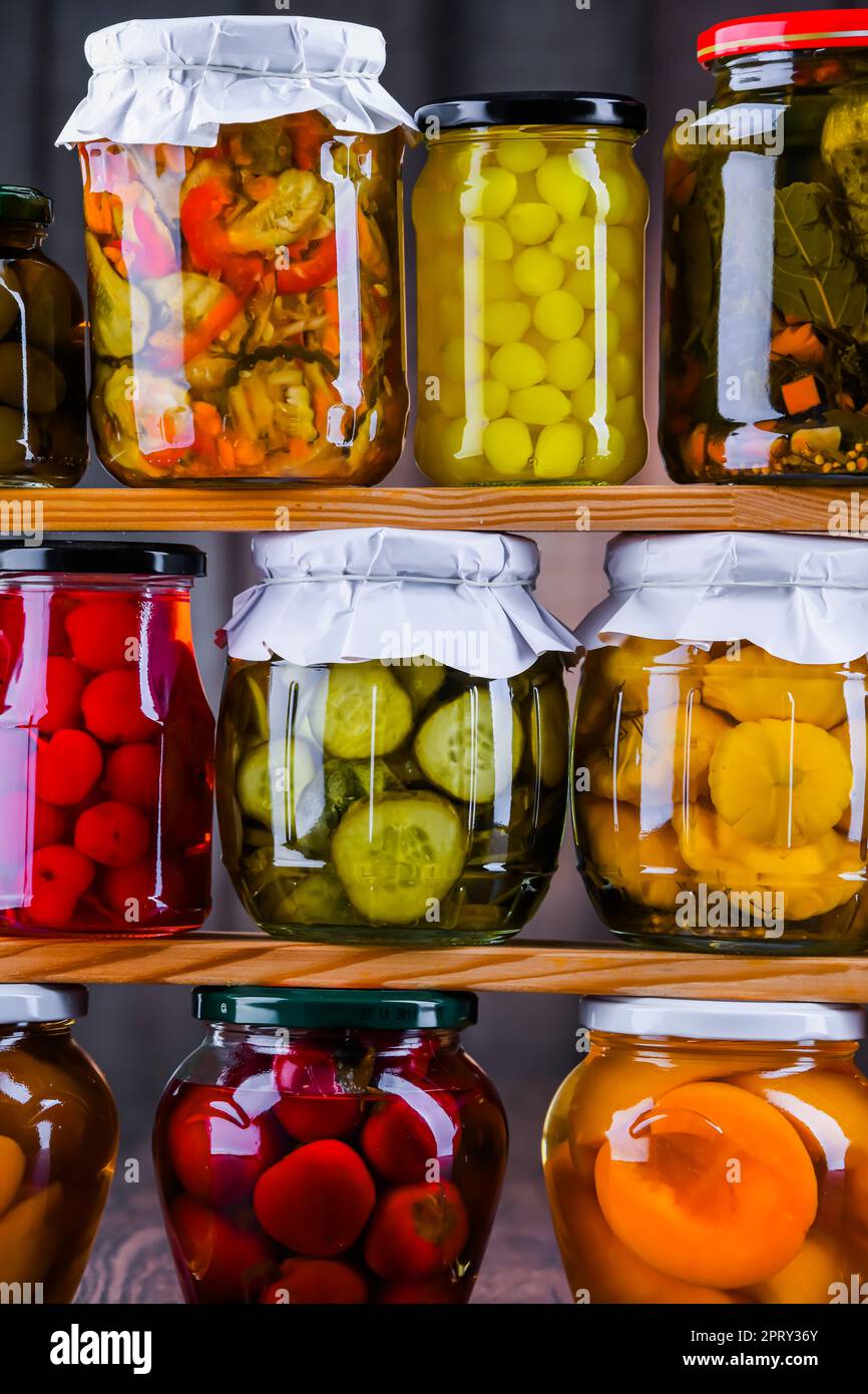 Jars with variety of marinated vegetables and fruits. Preserved food ...