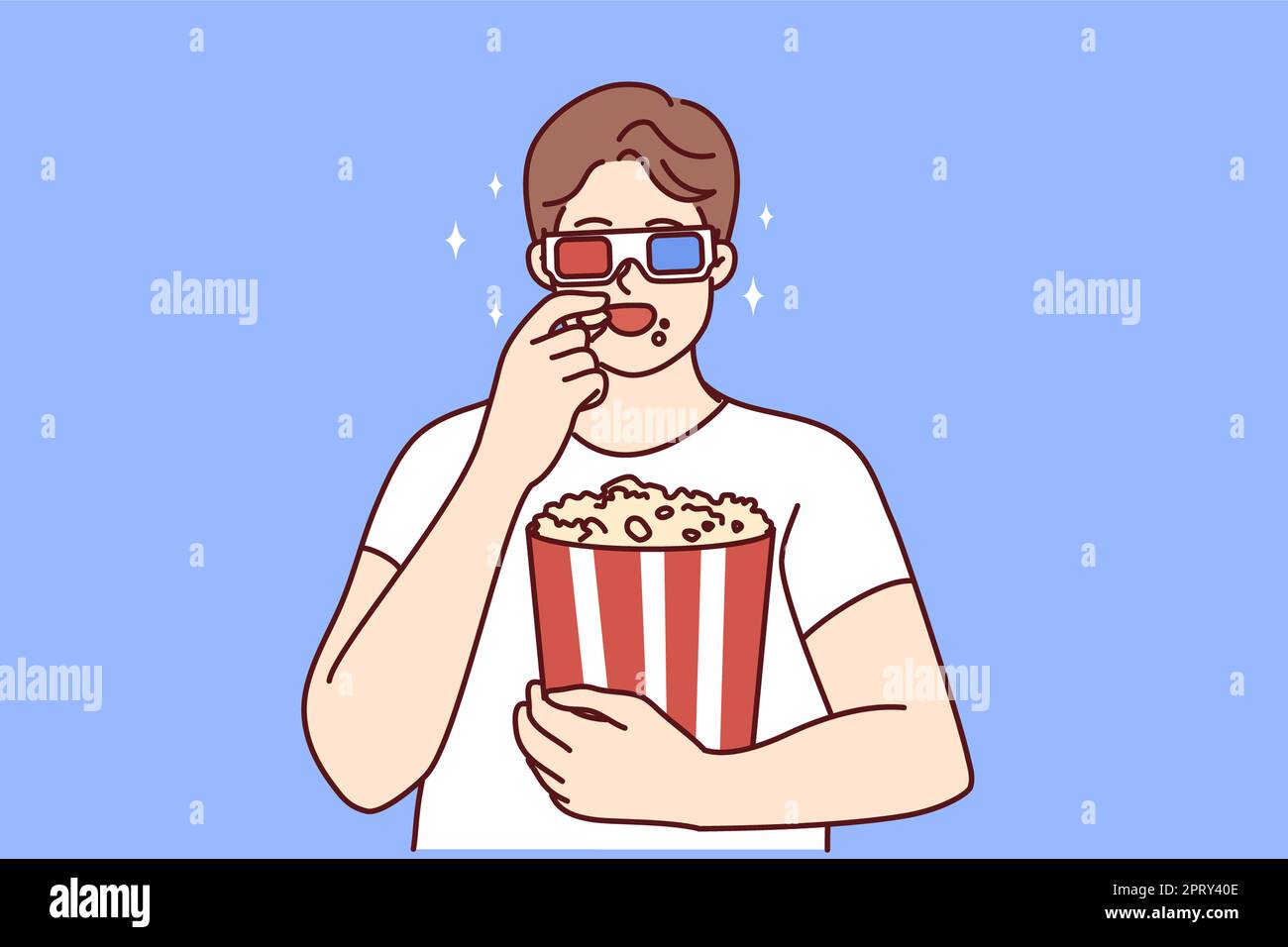 Happy young man in 3D glasses eating popcorn watching movie in cinema. Smiling male have snack ...