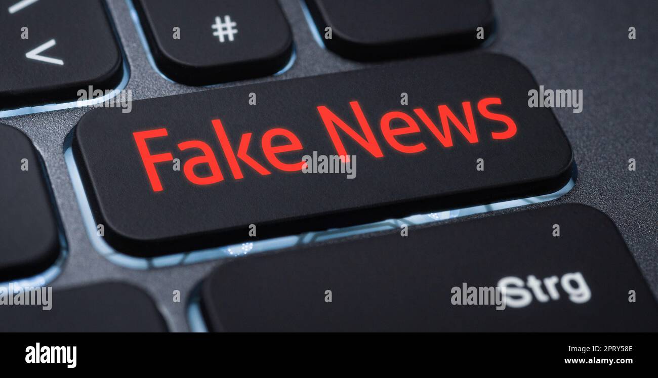 Illuminated keyboard with a labeled key - Fake News Stock Photo - Alamy